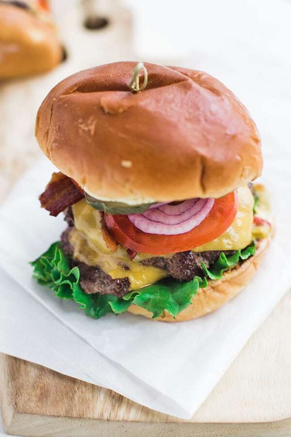 Classic Cheeseburger Recipe on Brioche with Lettuce Tomato and Onions ...
