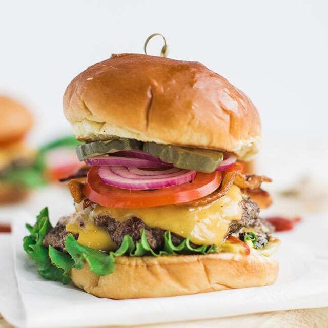 Classic Cheeseburger Recipe on Brioche with Lettuce Tomato and Onions ...